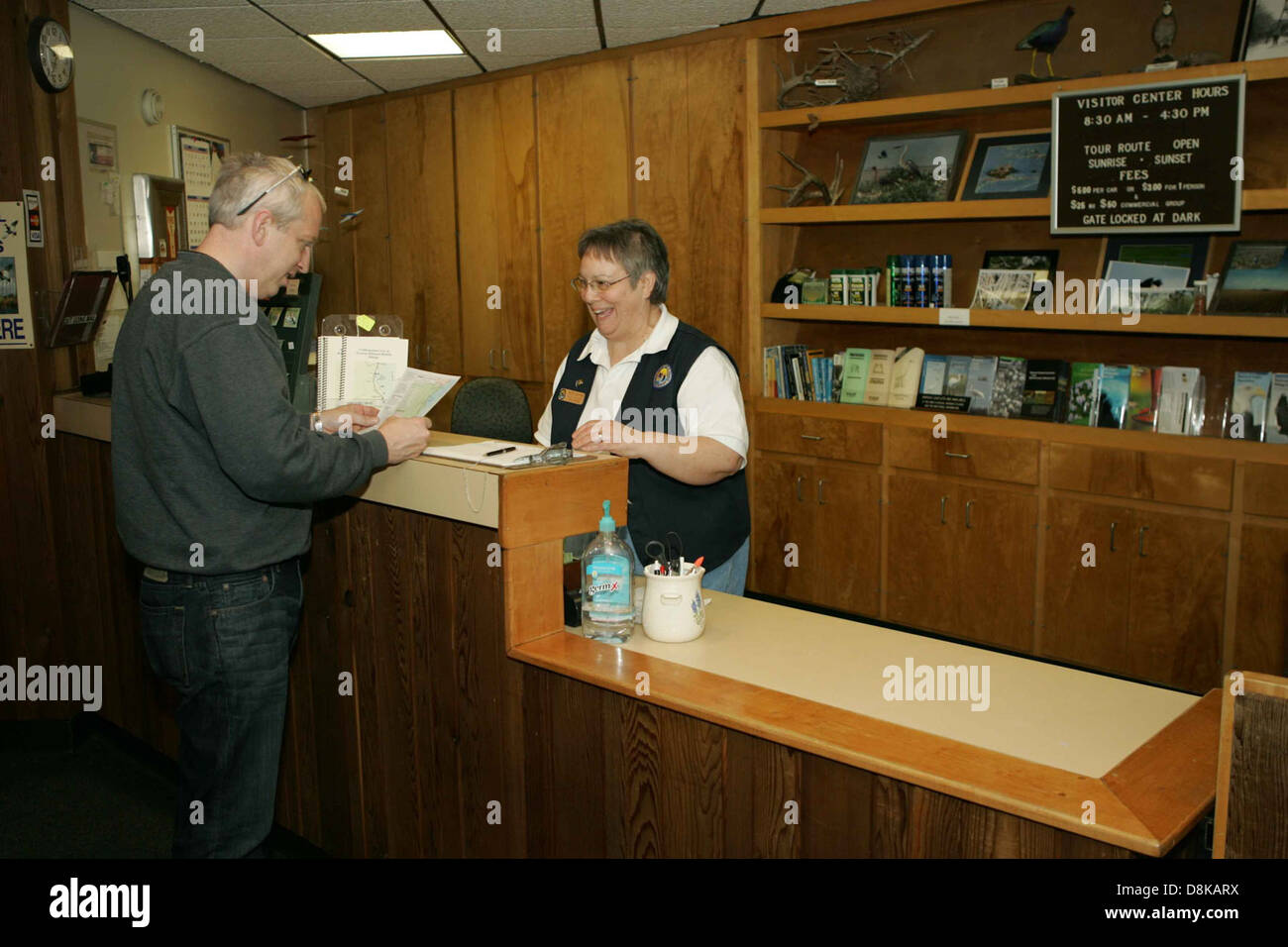 A happy visitor receives excellent customer service in a hospitality ...