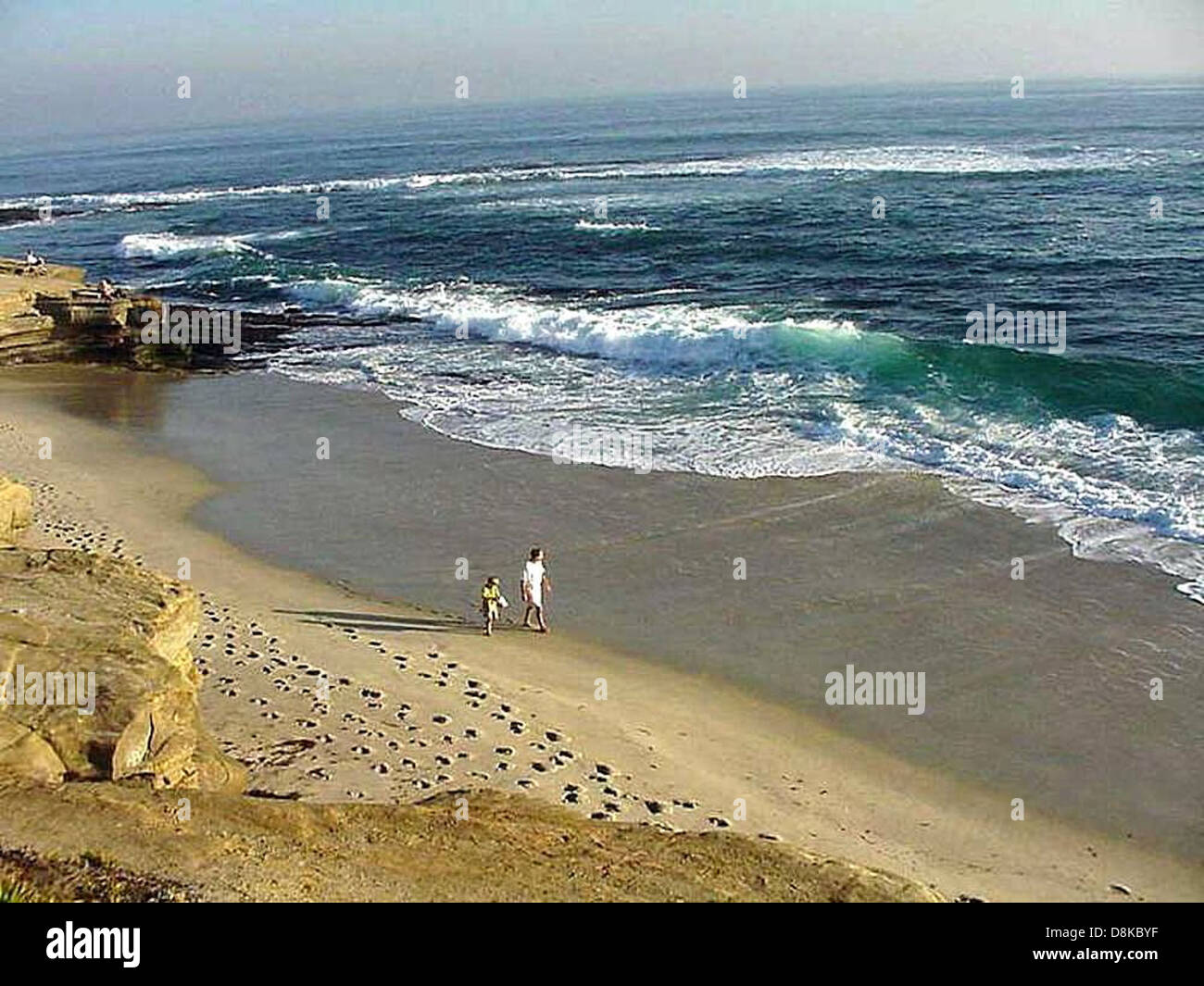 This image captures a pristine white sand beach, with fine, powdery ...