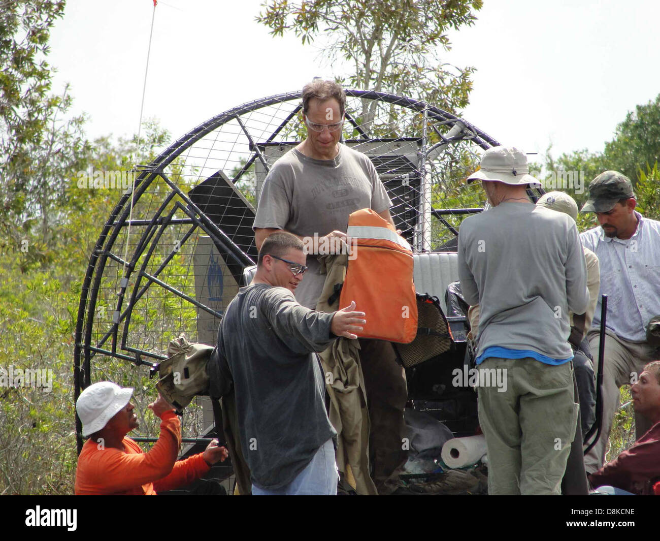 A crew is shown working aboard a wind boat, a type of boat powered by ...