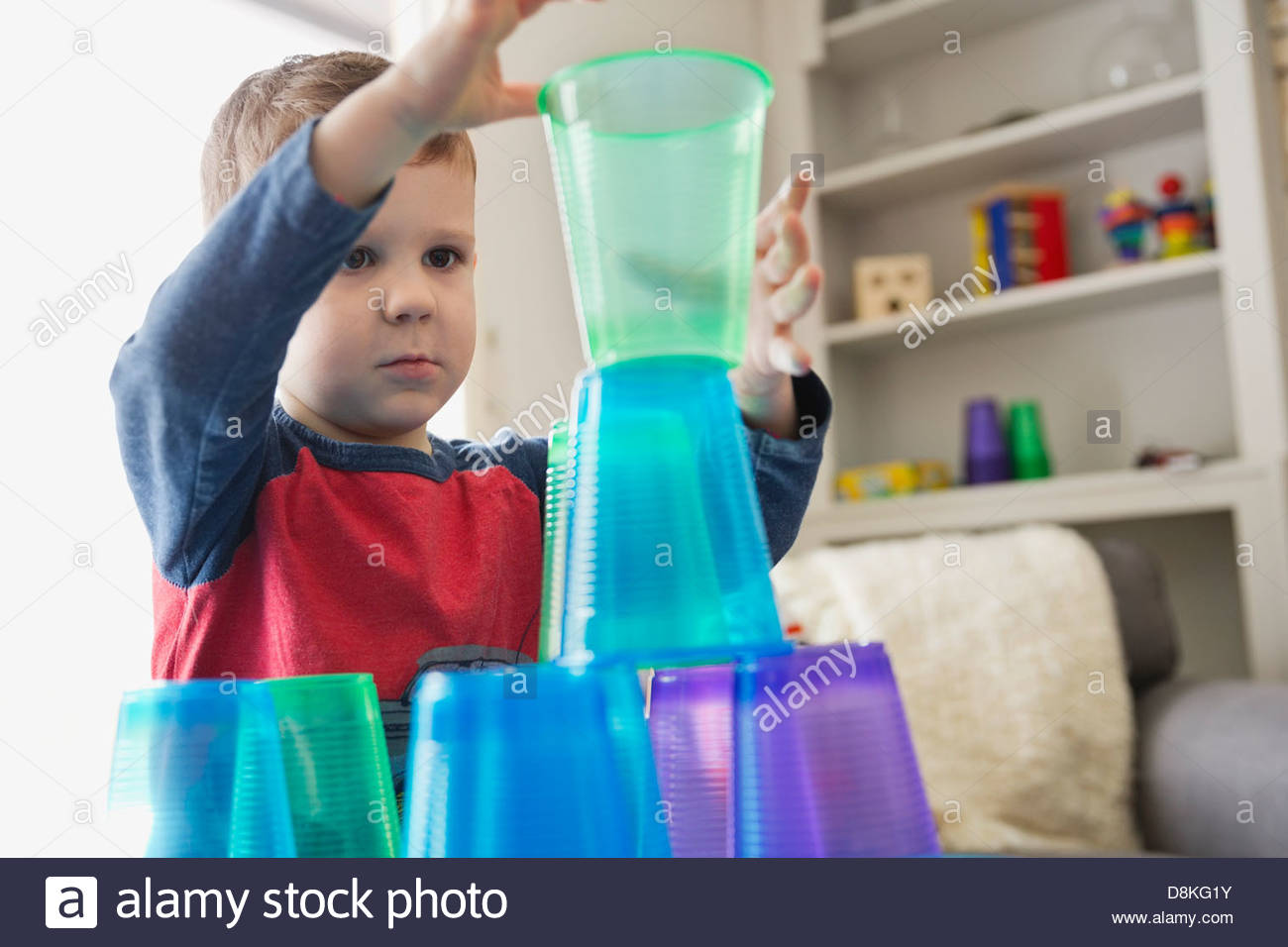 Boy playing with plastic cups at home Stock Photo - Alamy