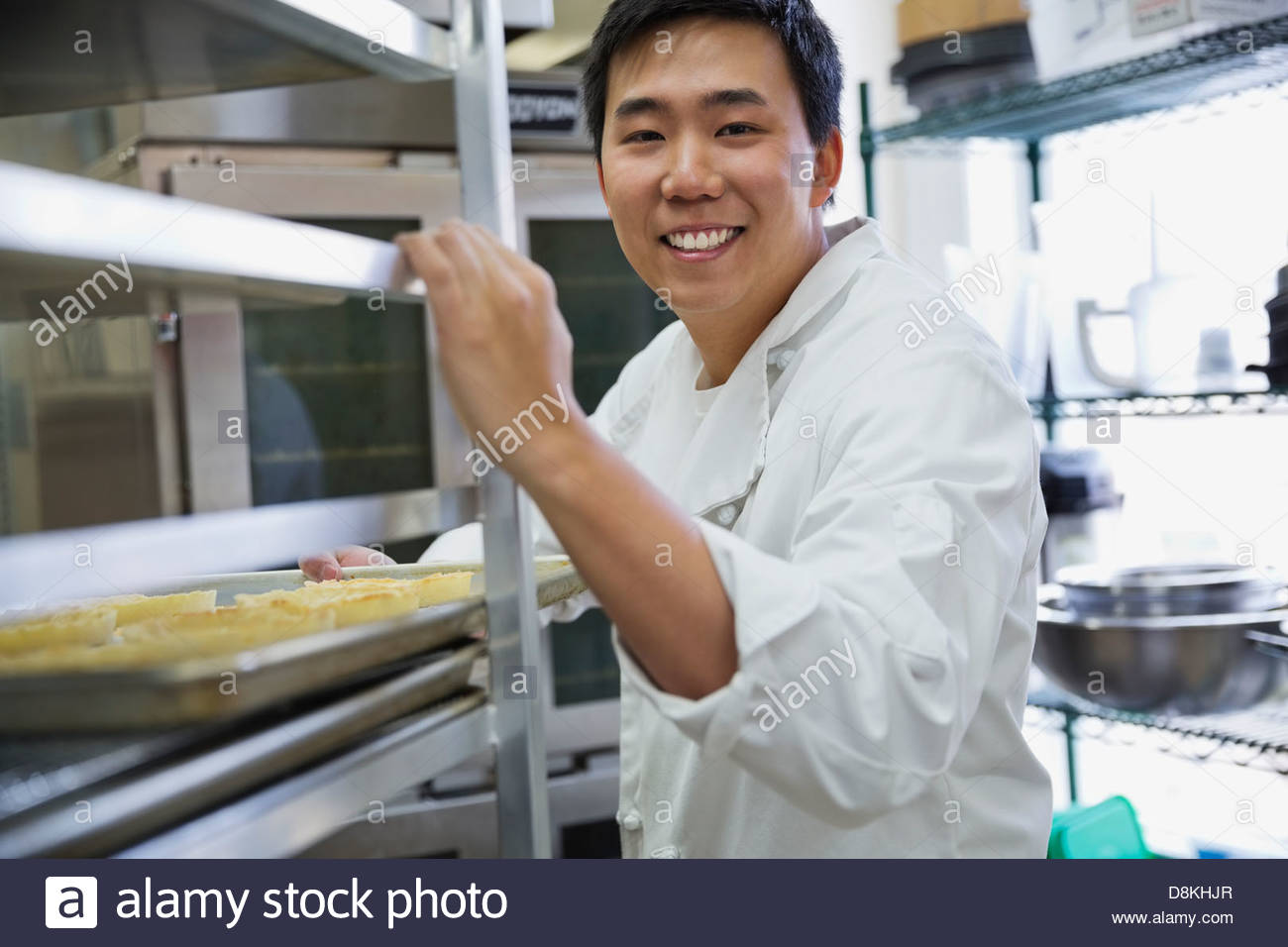 Portrait of young male baker working in bakery Stock Photo - Alamy