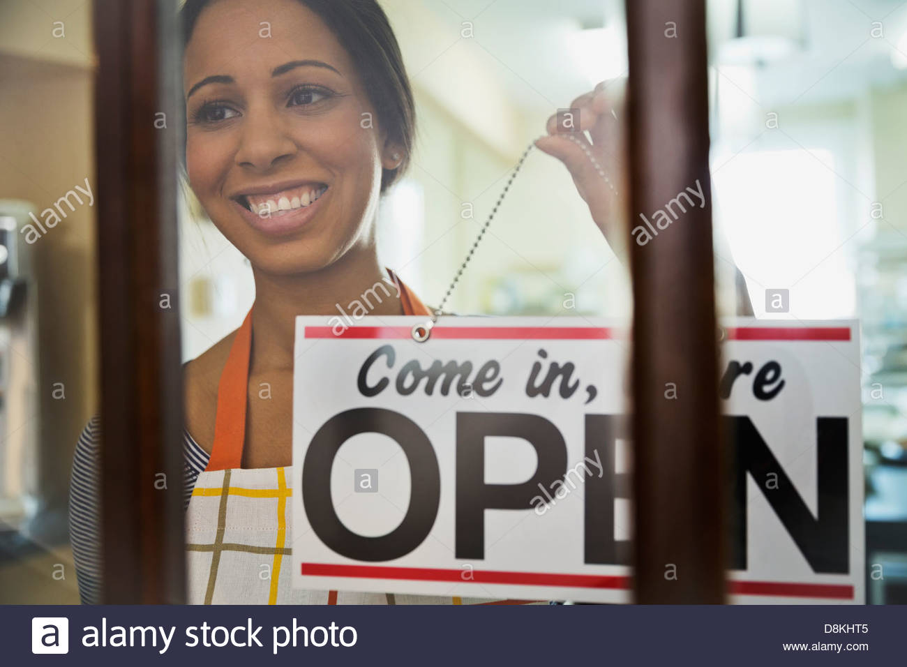 Women hanging open sign hi-res stock photography and images - Alamy