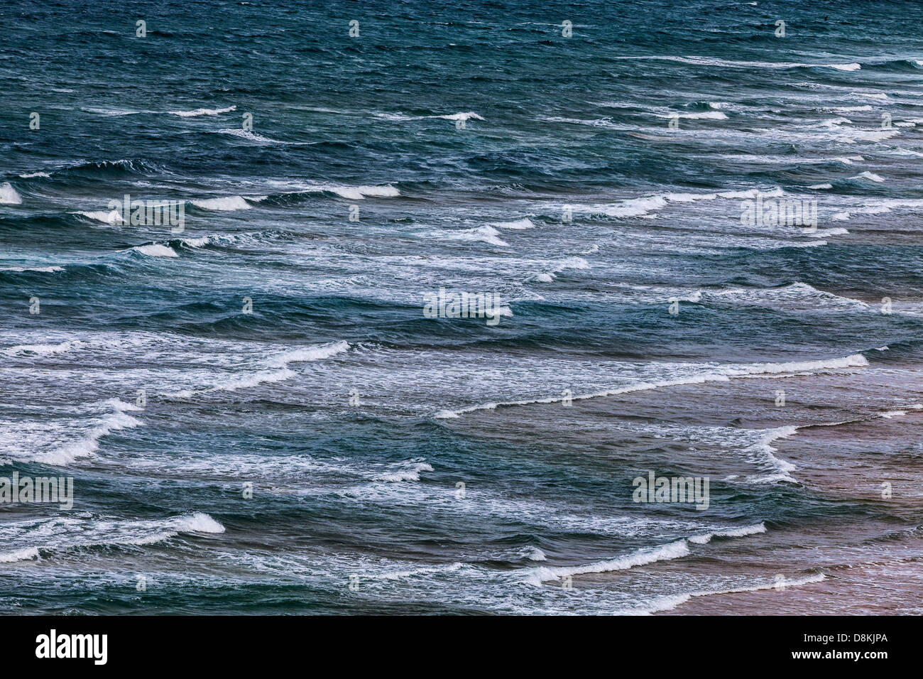 Aerial view of small waves on a beach at the Atlantic Ocean, creating a ...
