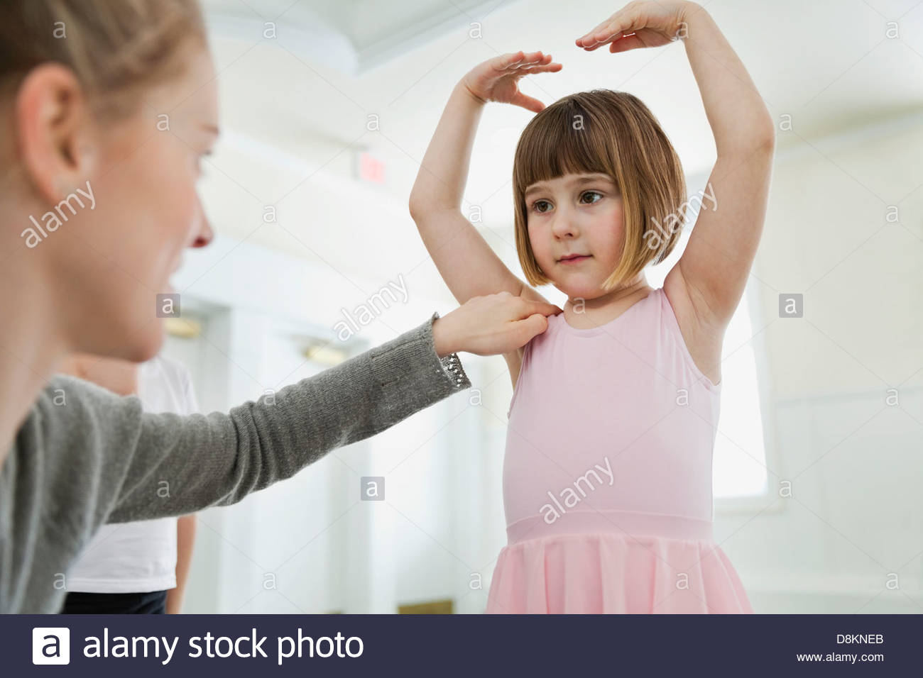 Female ballet instructor teaching girl in ballet studio Stock Photo - Alamy