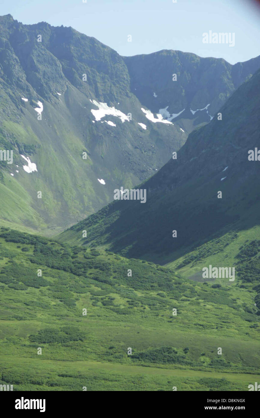 A scenic view of green hills rolling into distant mountains, under a ...