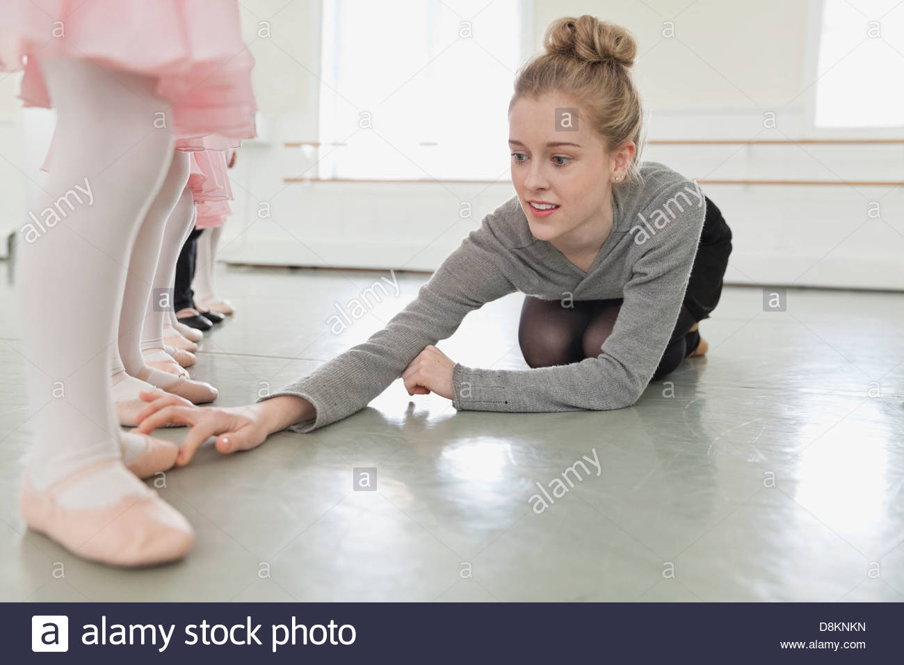 Female ballet instructor teaching children in ballet studio Stock Photo ...