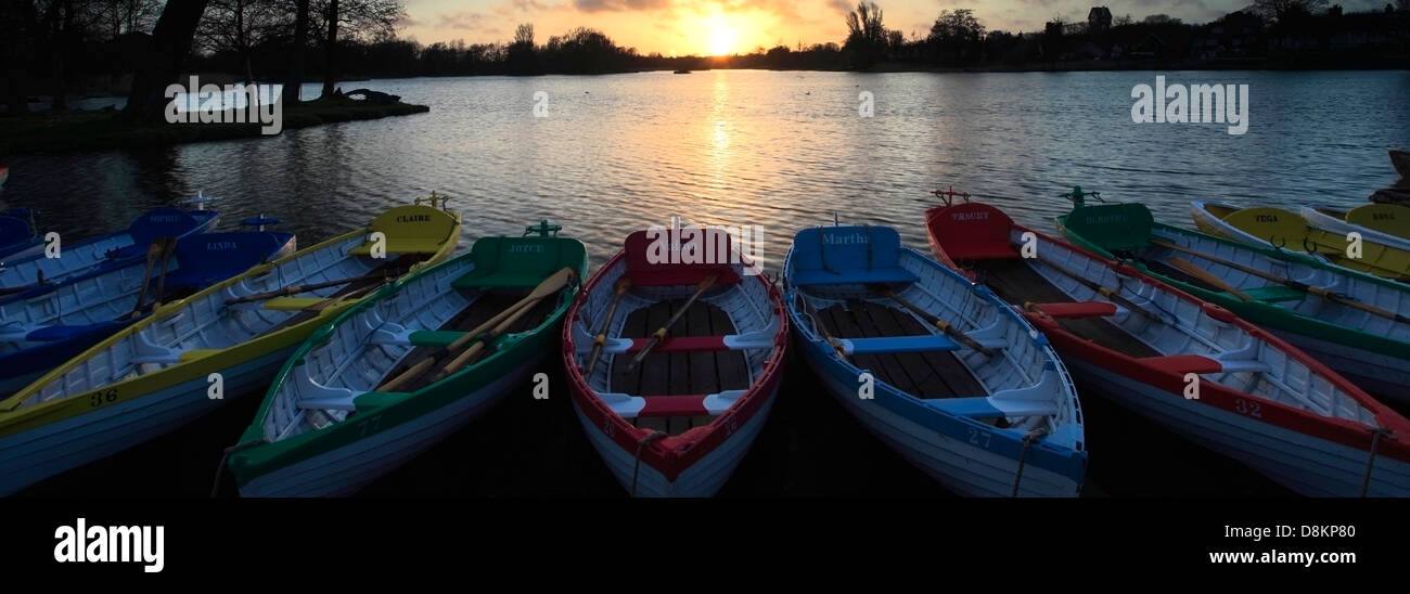 Colourful wooden rowing boats for hire on the Mere lake, Thorpeness ...