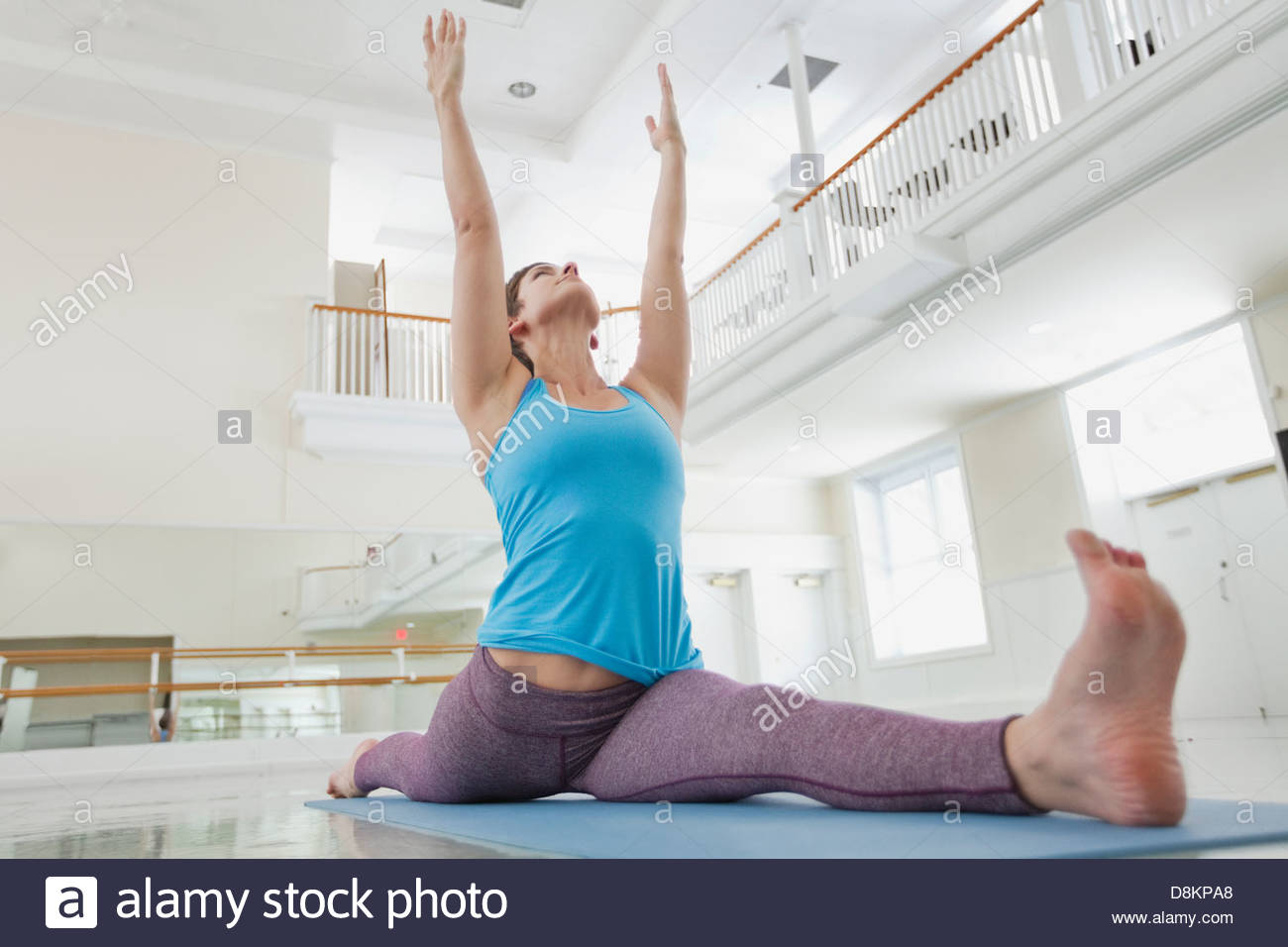 Woman practicing yoga in yoga studio Stock Photo - Alamy