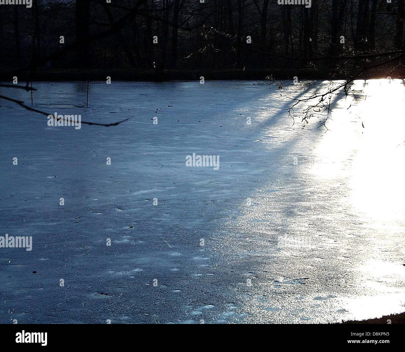 A frozen lake with a layer of ice covering its surface. The image ...