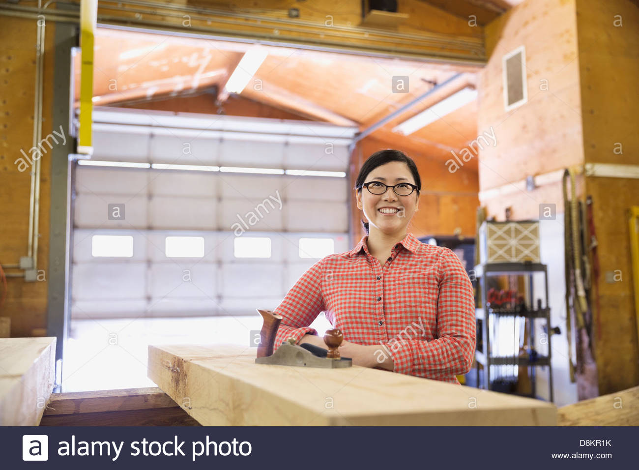 Happy female carpenter in workshop Stock Photo - Alamy