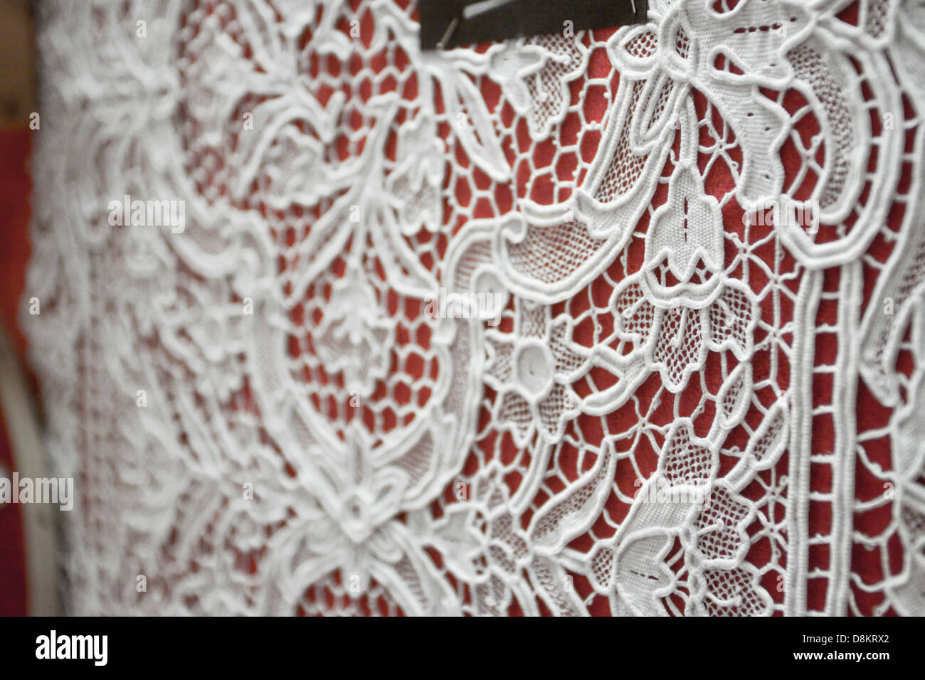 A detail of a decorated ornamental doily over red background Stock ...