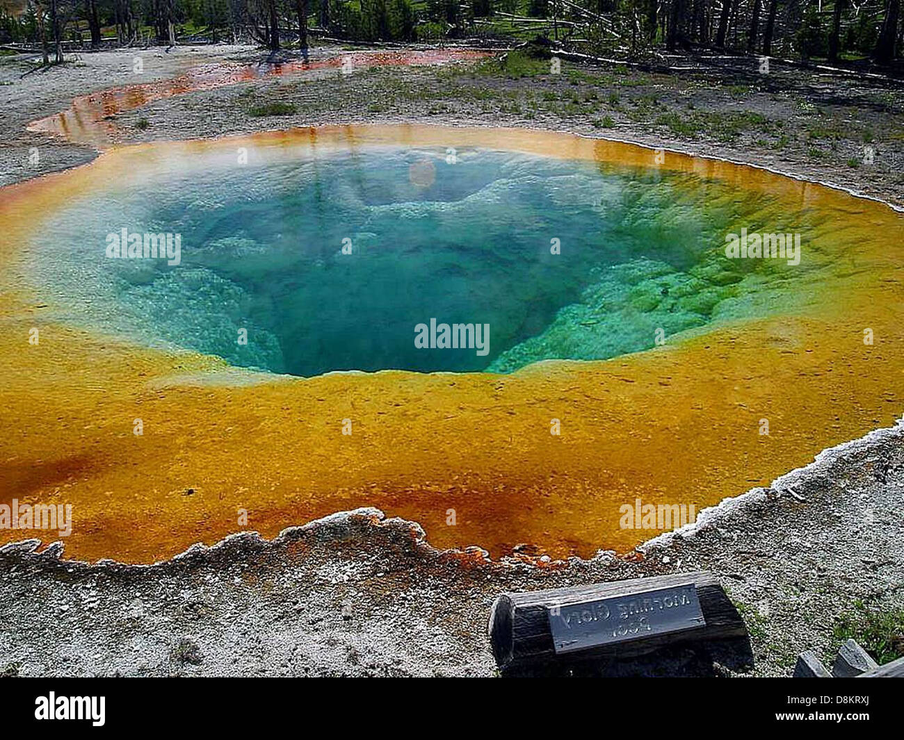 A natural thermal hot spring surrounded by rocky terrain. The warm ...