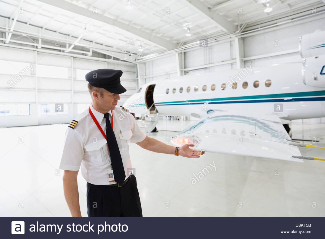 Male pilot checking airplane wing hi-res stock photography and images ...