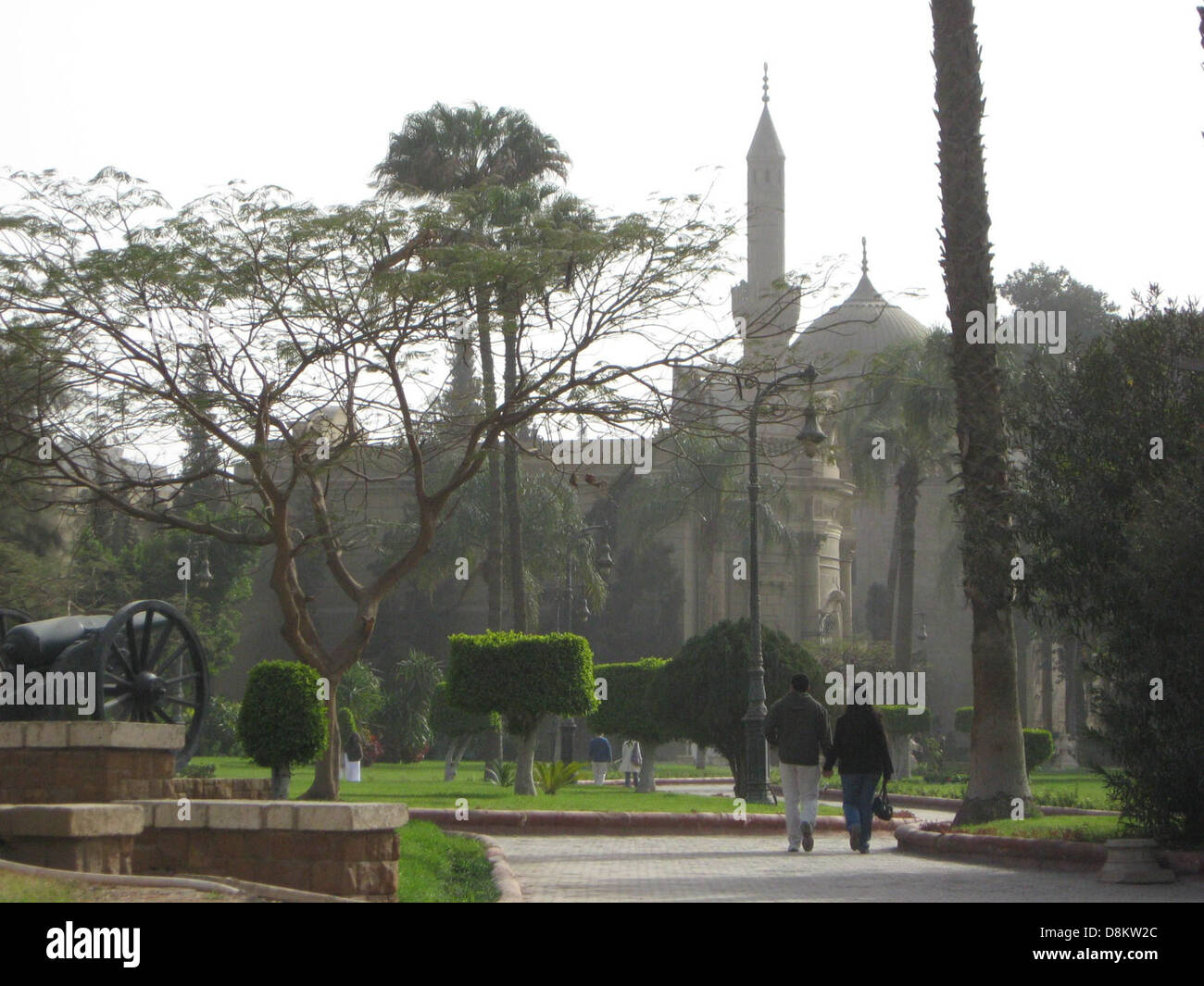 A couple strolls through a lush garden in Cairo, Egypt, surrounded by ...