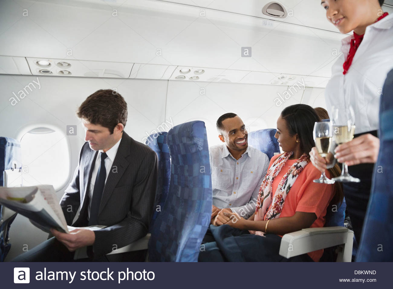Flight attendant serving drinks to passengers Stock Photo - Alamy Flight attendant serving drinks to passengers Stock Photo - Alamy