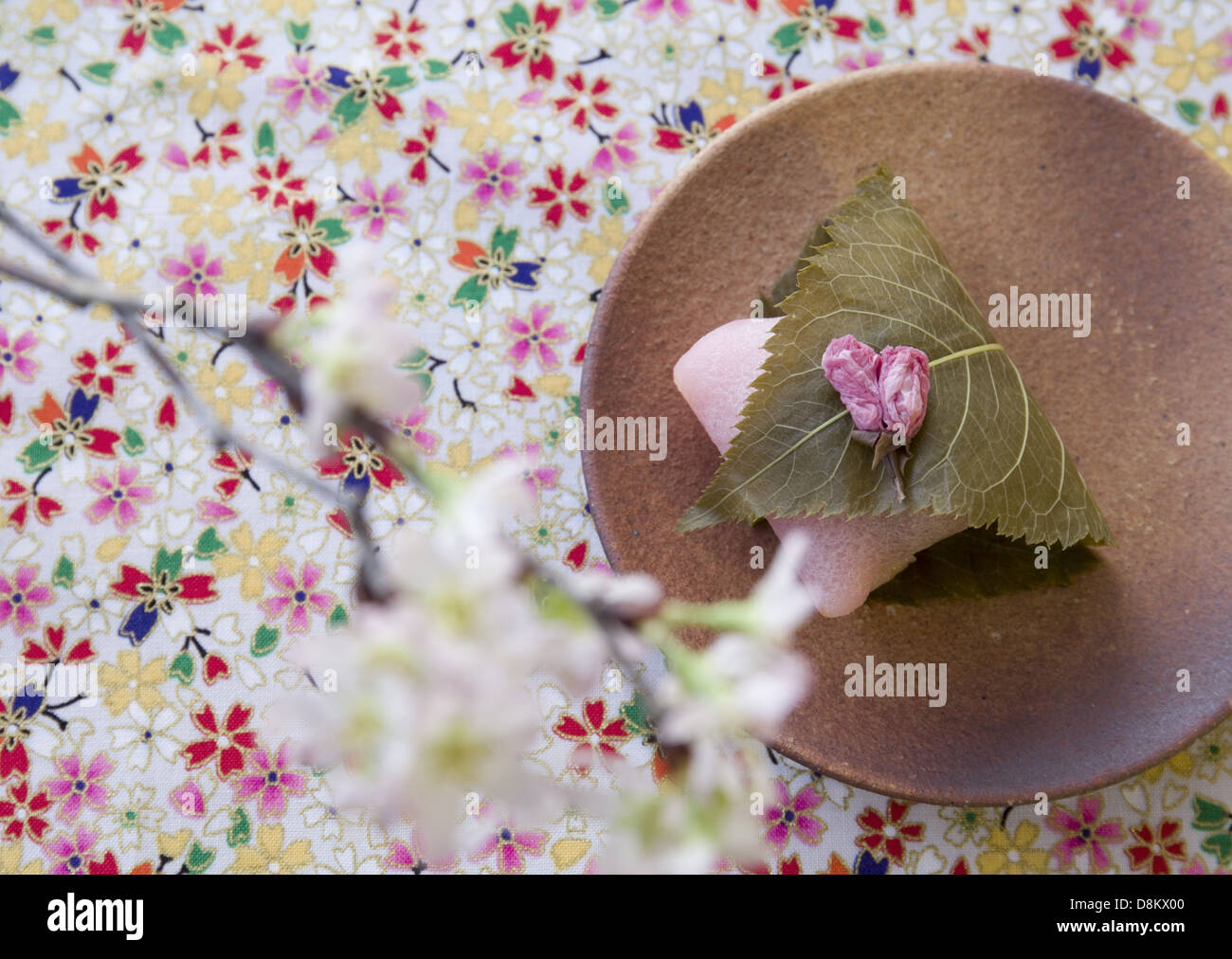 Sakura mochi (cherry flavored soft sweet rice cake) and cherry blossoms Stock Photo - Alamy