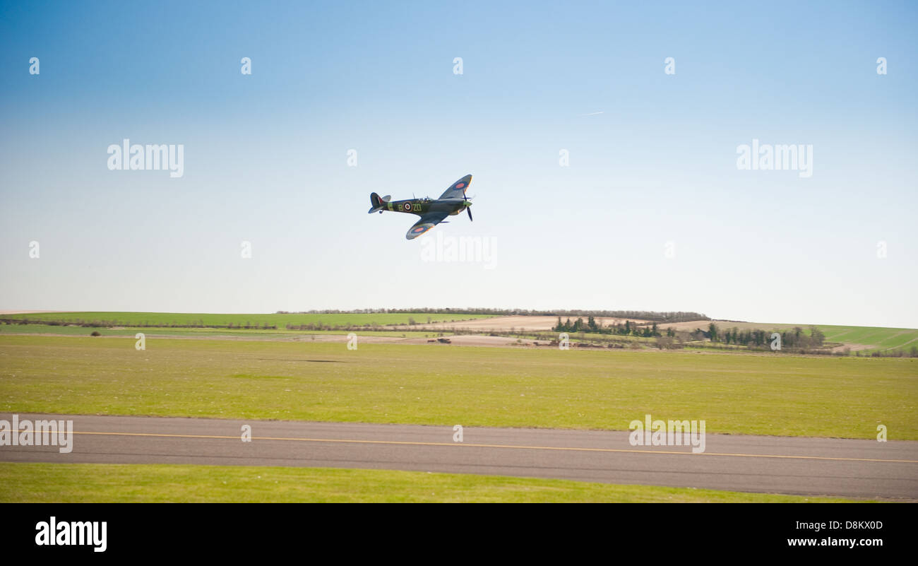 A Supermarine Spitfire flying over Duxford Aerodrome,Cambridgeshire ...