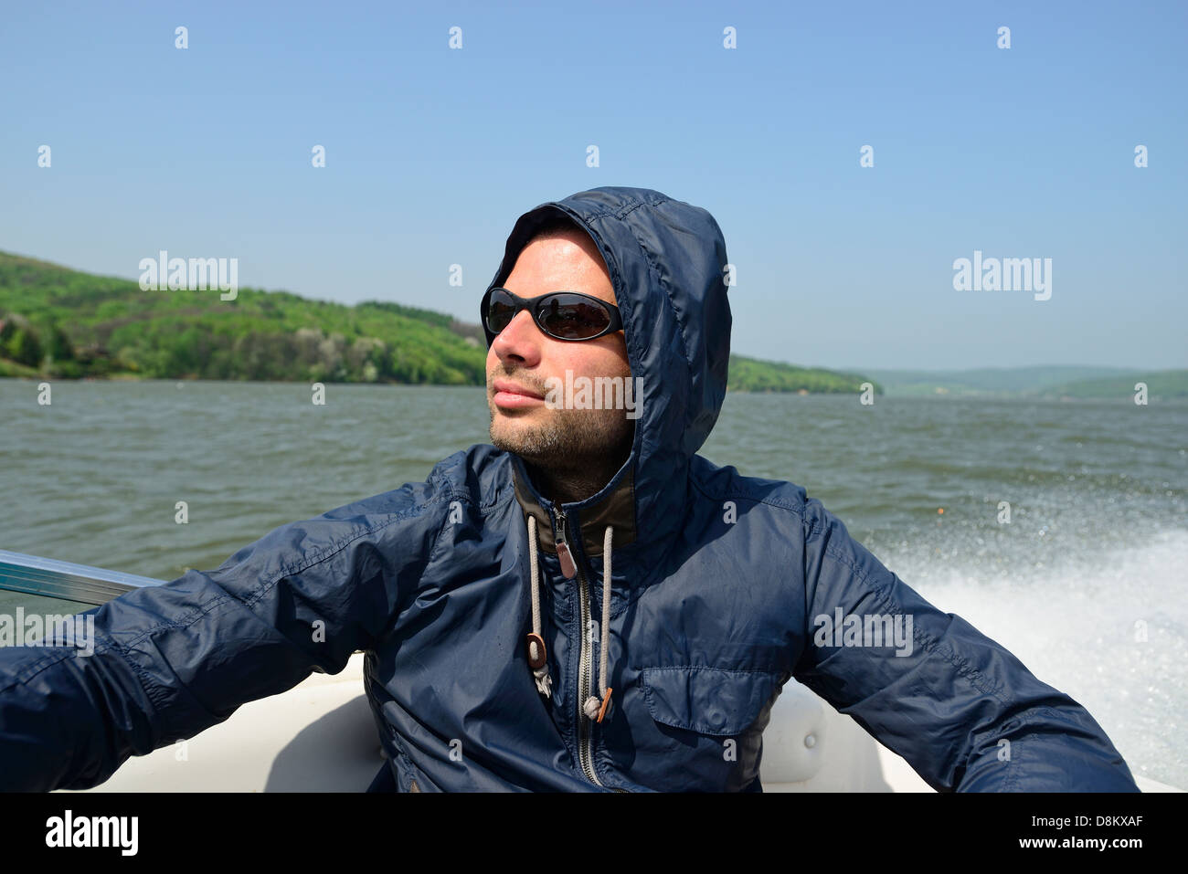 Man in a motorboat speeding along the shores Stock Photo - Alamy
