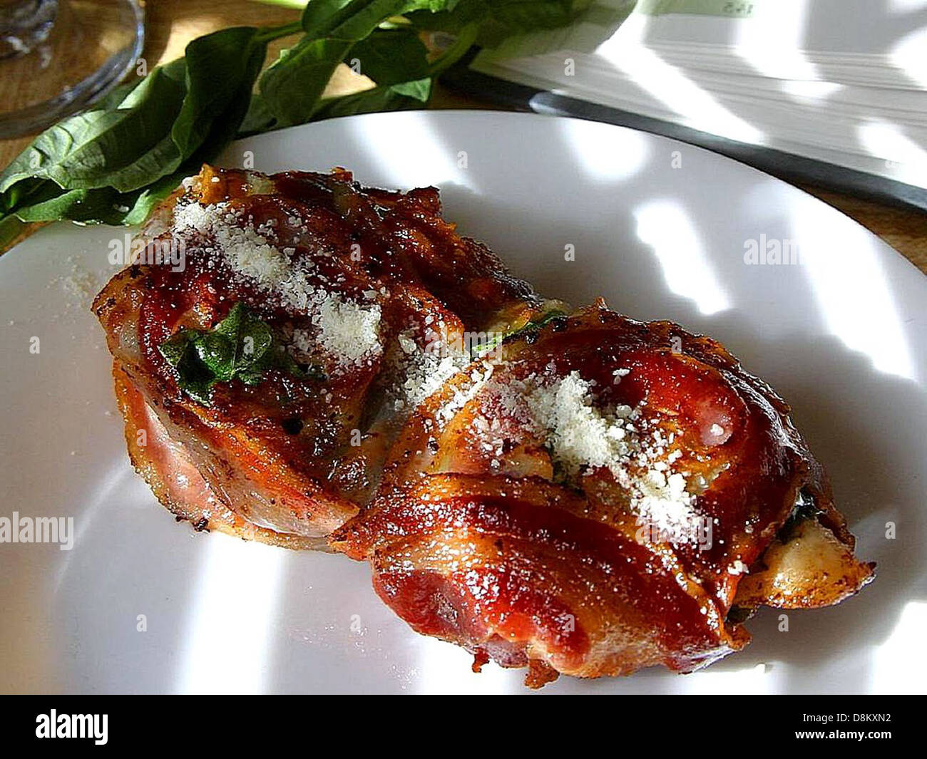 Pancetta and basil wrapped chicken Stock Photo - Alamy