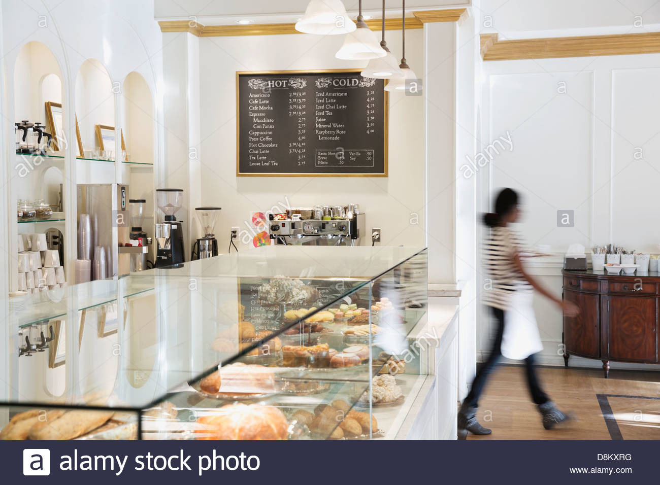 Woman employee working in coffee shop Stock Photo - Alamy