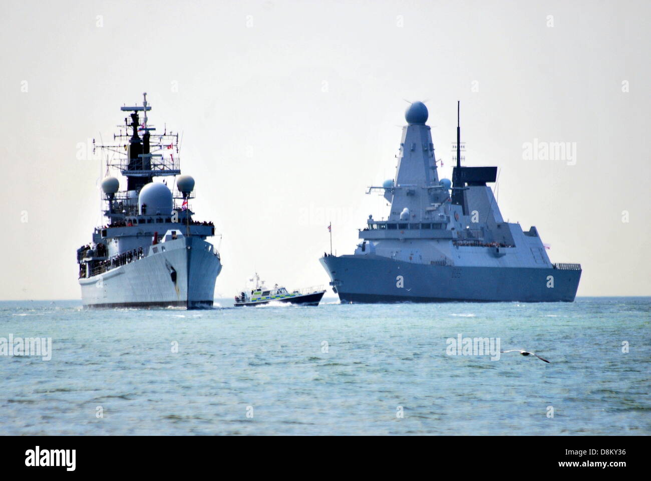 The Royal Navy Destroyer HMS Edinburgh, pictured left is escorted into ...