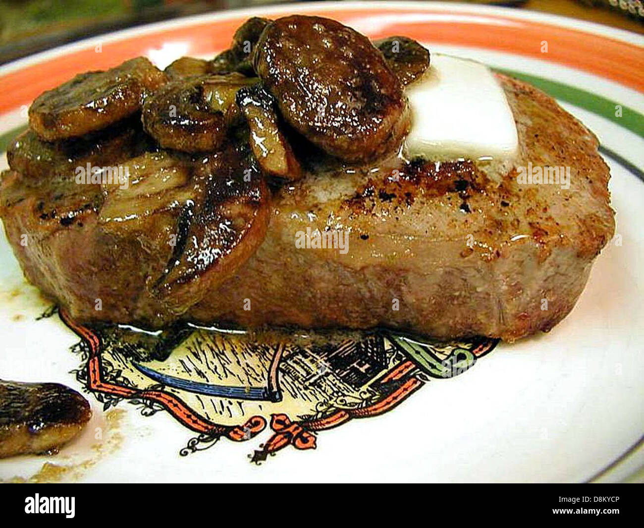 A delicious plate of steak served with a rich butter sauce and sautéed ...