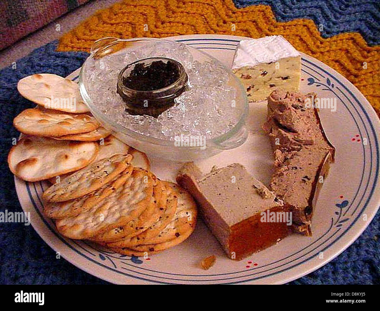 A gourmet dish of Thanksgiving brie cheese, caviar, and duck pâté ...