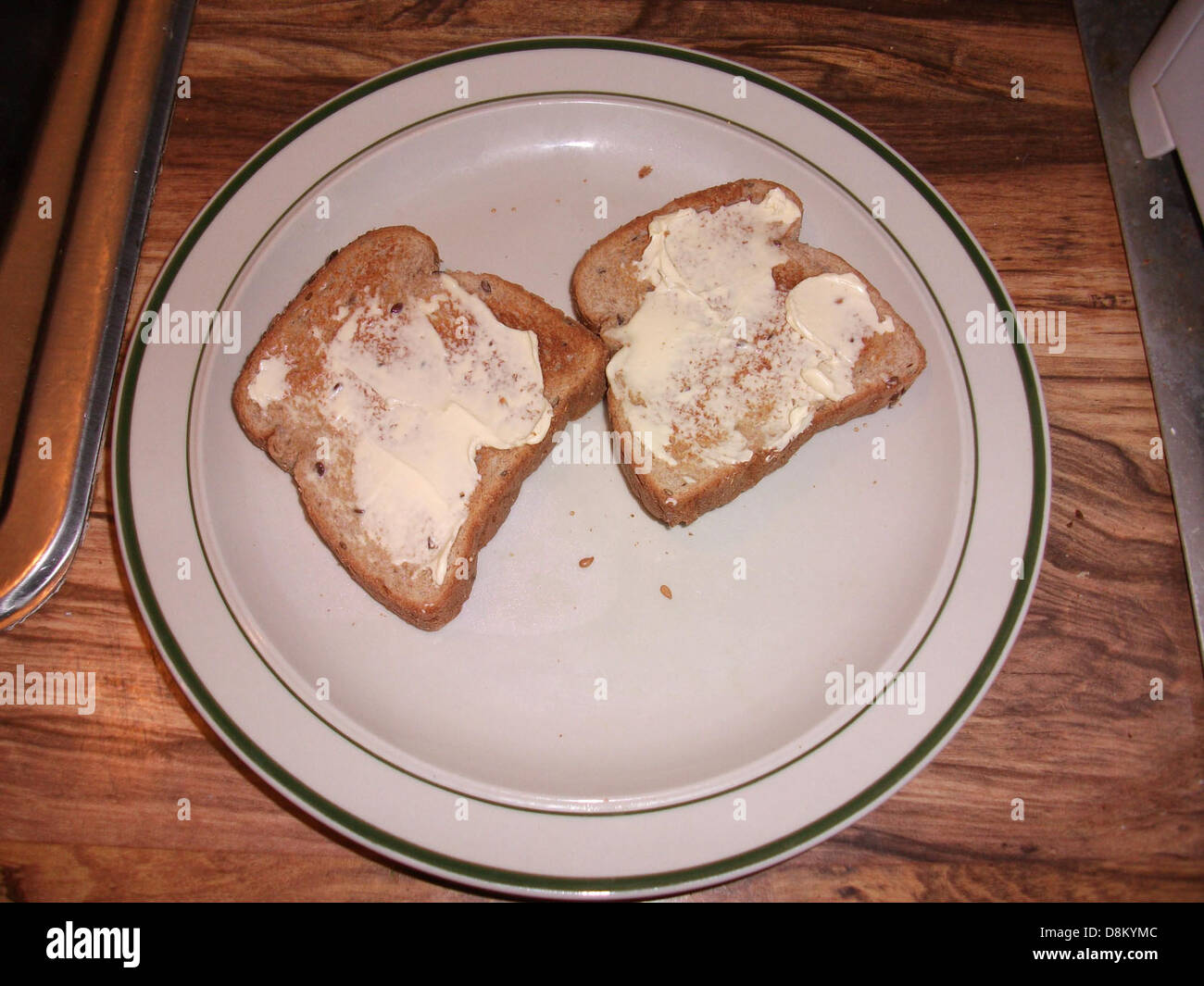 This image shows a slice of toast with a generous amount of butter ...