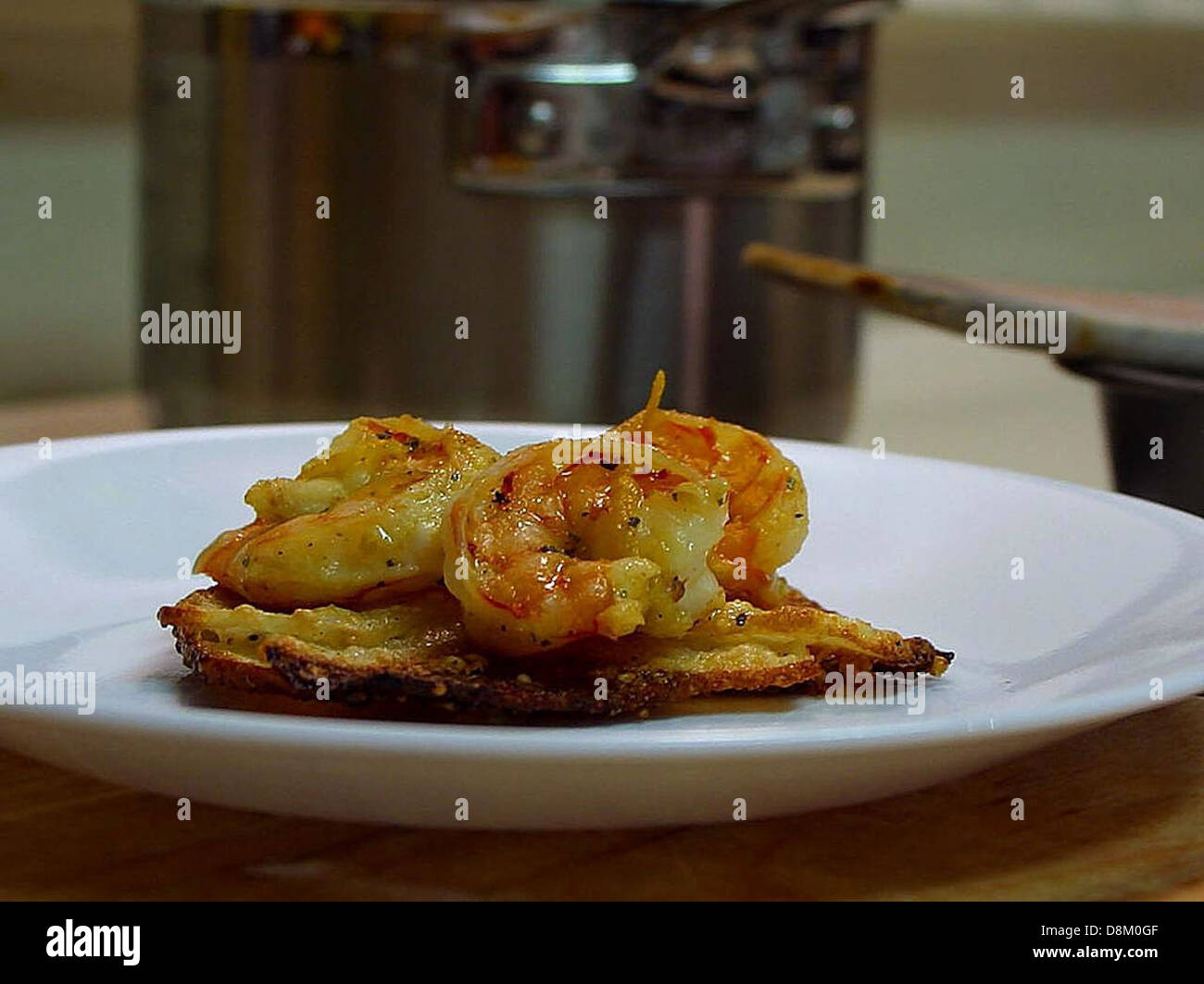 Adobo shrimp on potato galettes Stock Photo - Alamy