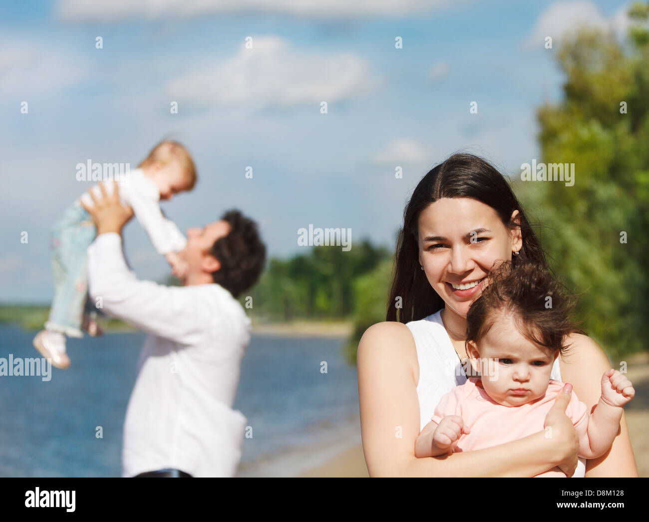 Happy young family with two children Stock Photo - Alamy