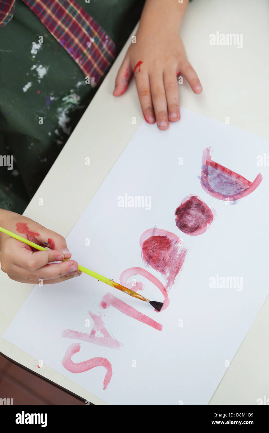 Boy Painting Name On Paper In Art Class Stock Photo - Alamy