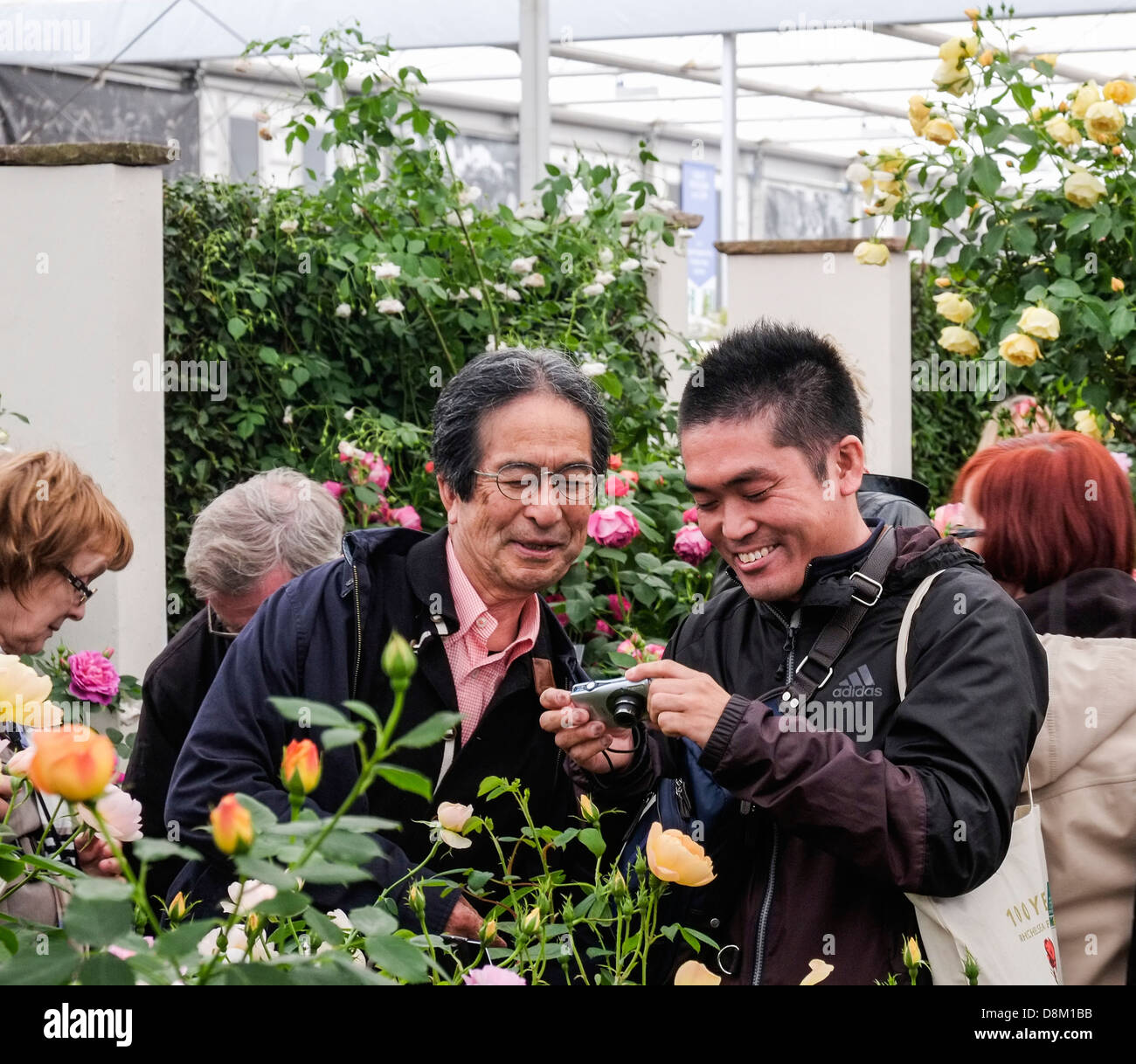 Two happy Japanese at the Chelsea Flower show Stock Photo - Alamy