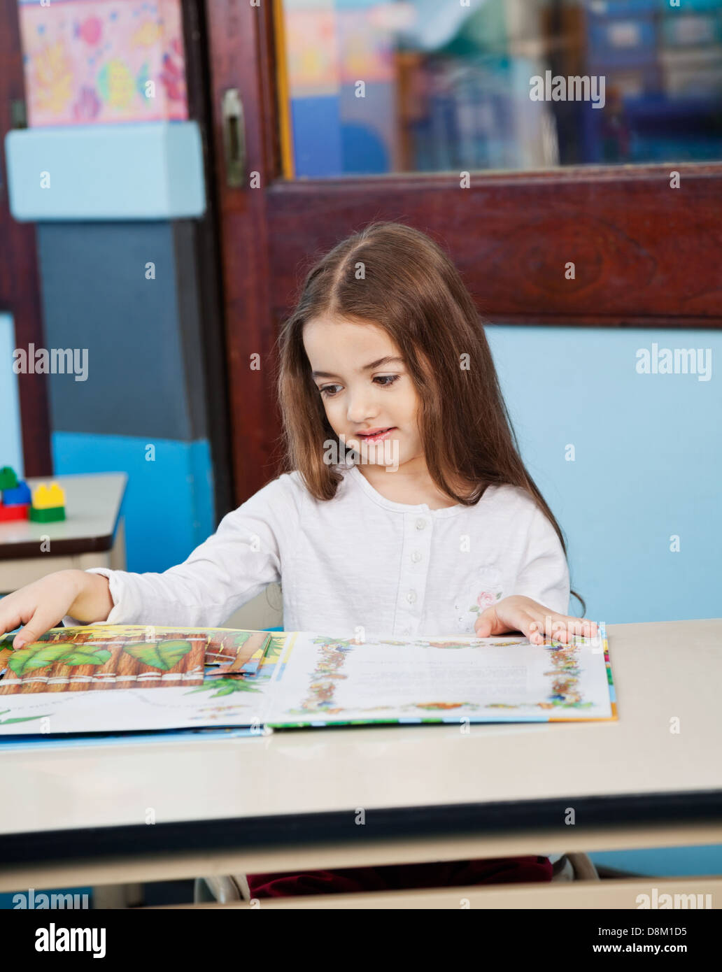 Girl Opening Popup Book At Desk In Stock Photo - Alamy