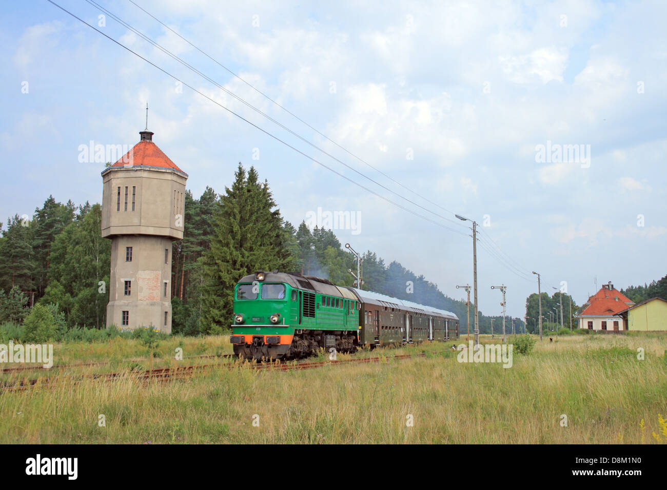 Passenger train starting from the station Stock Photo - Alamy