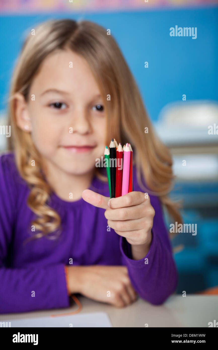 Girl Holding Color Pencils In Kindergarten Stock Photo - Alamy