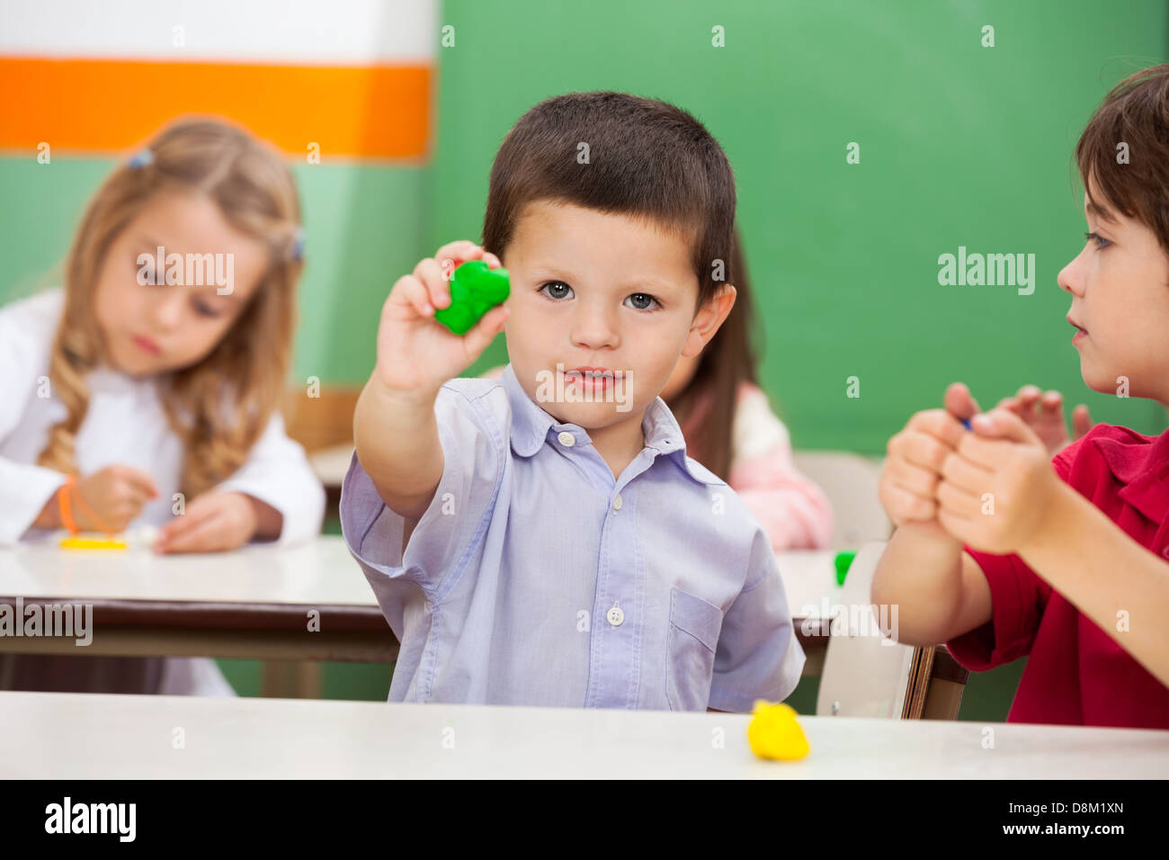 Boy Showing Clay At Classroom Stock Photo - Alamy