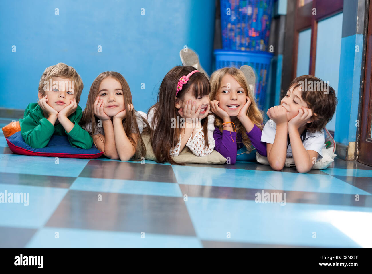Children Lying In A Row On Floor Stock Photo - Alamy