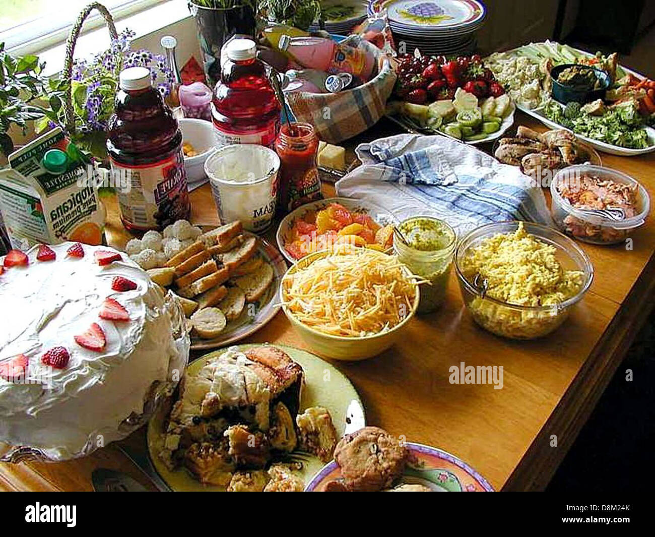 A selection of food items including cheesecakes and fruit juices. The ...