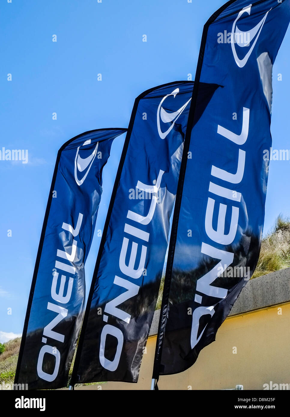 Flags advertising a surfing company Stock Photo - Alamy