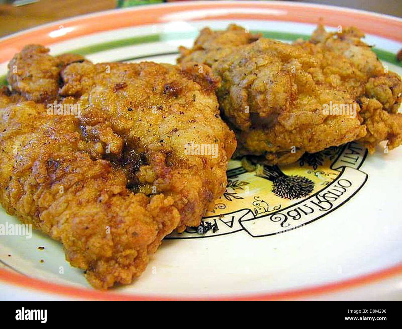 A plate of crispy fried chicken, served golden brown and crunchy. The ...