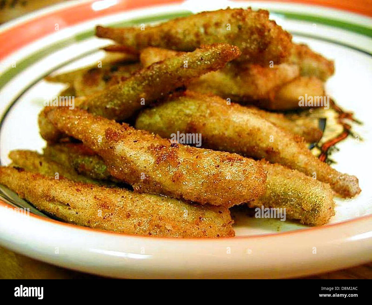 A plate of fried smelt, a small fish variety, served as a crispy dinner ...
