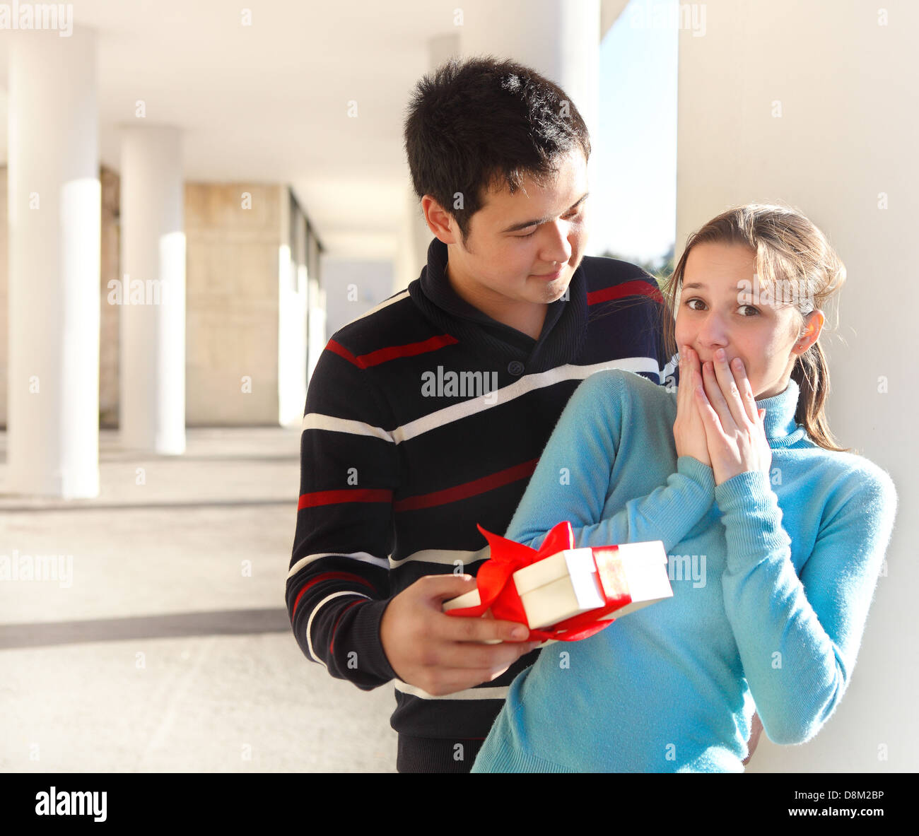 Happy young couple in love with present Stock Photo - Alamy