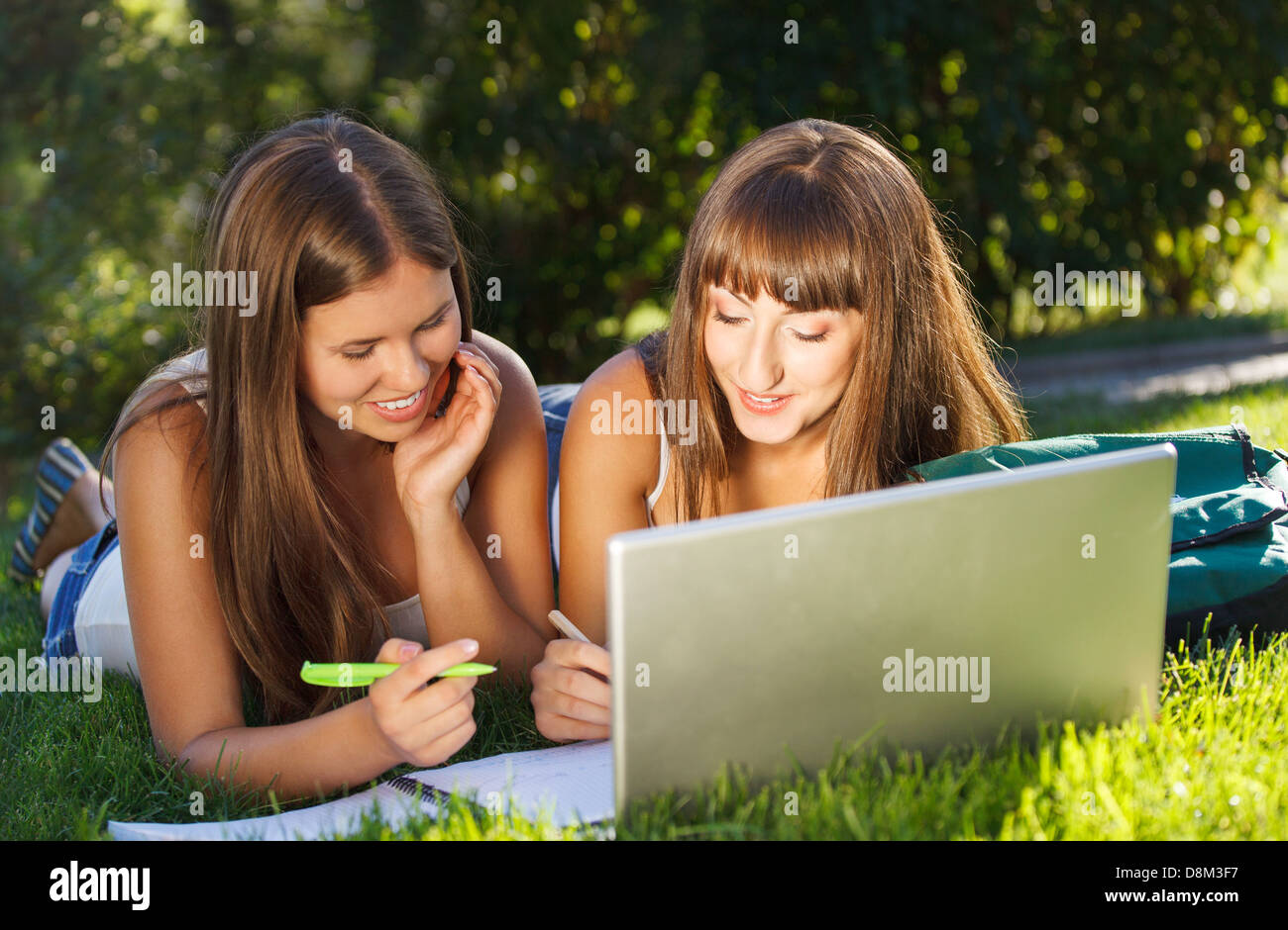 Happy young girls using a computer Stock Photo - Alamy
