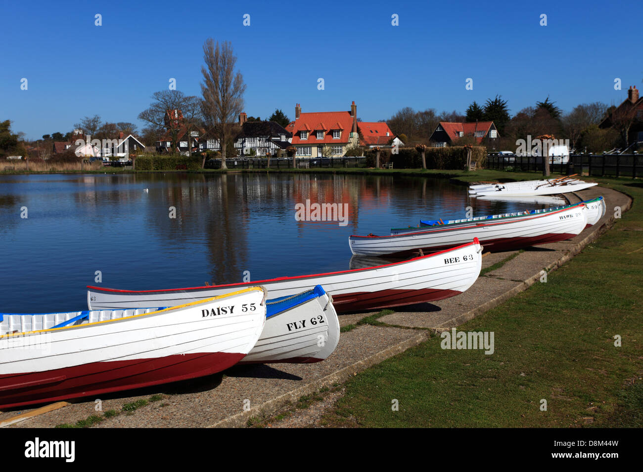 Colourful wooden rowing boats for hire on the Mere lake, Thorpeness ...
