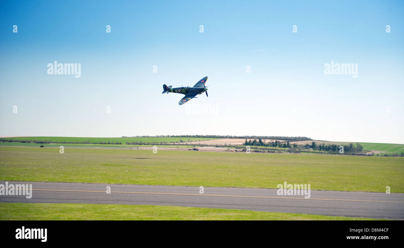A Supermarine Spitfire flying over Duxford Aerodrome,Cambridgeshire ...