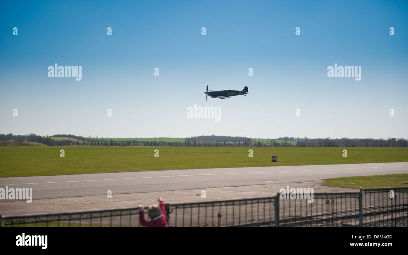 A Supermarine Spitfire flying over Duxford Aerodrome,Cambridgeshire ...