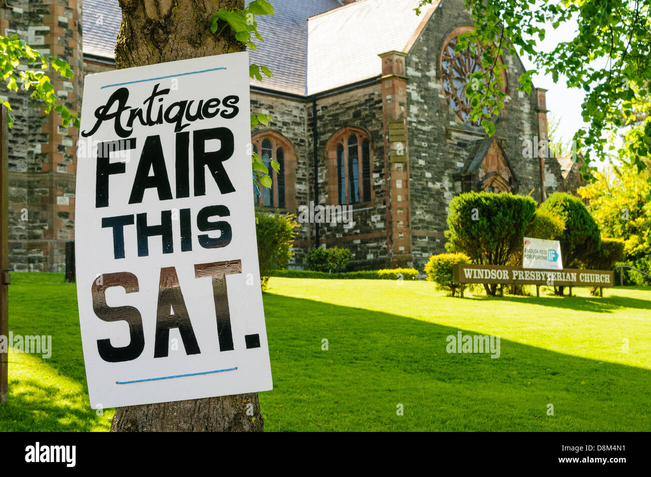 "Antiques Fair this Saturday" sign outside a church Stock Photo - Alamy