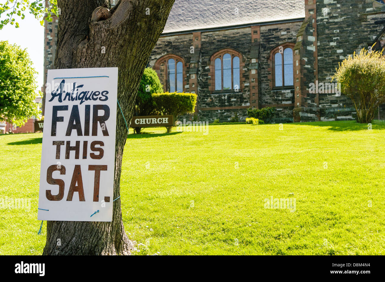 "Antiques Fair this Saturday" sign outside a church Stock Photo - Alamy