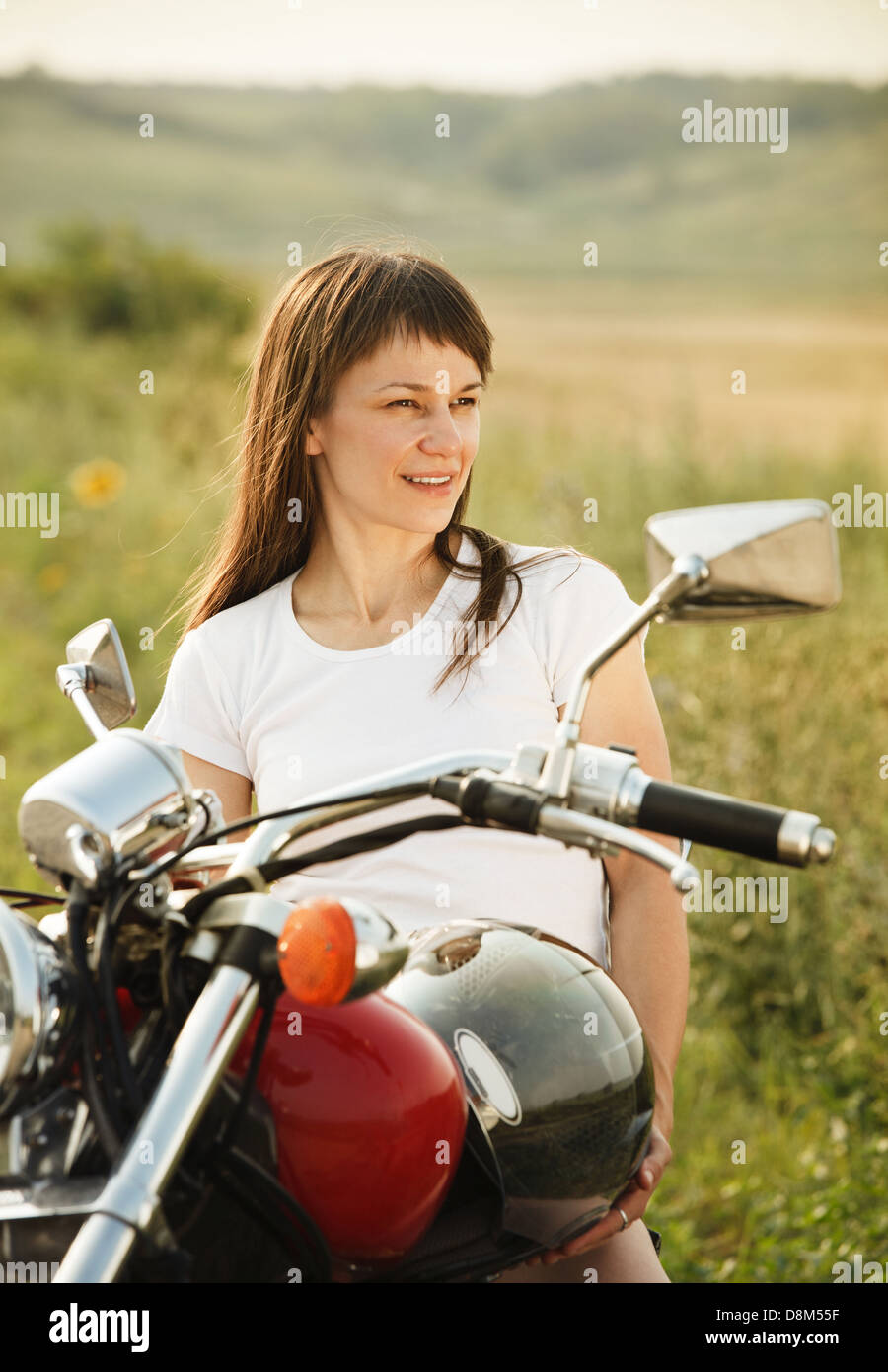 Young biker woman on the country road Stock Photo - Alamy