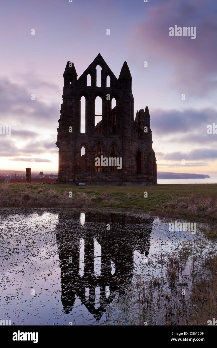 Whitby Abbey at sunset. The still pond reflecting the abbey used to be ...
